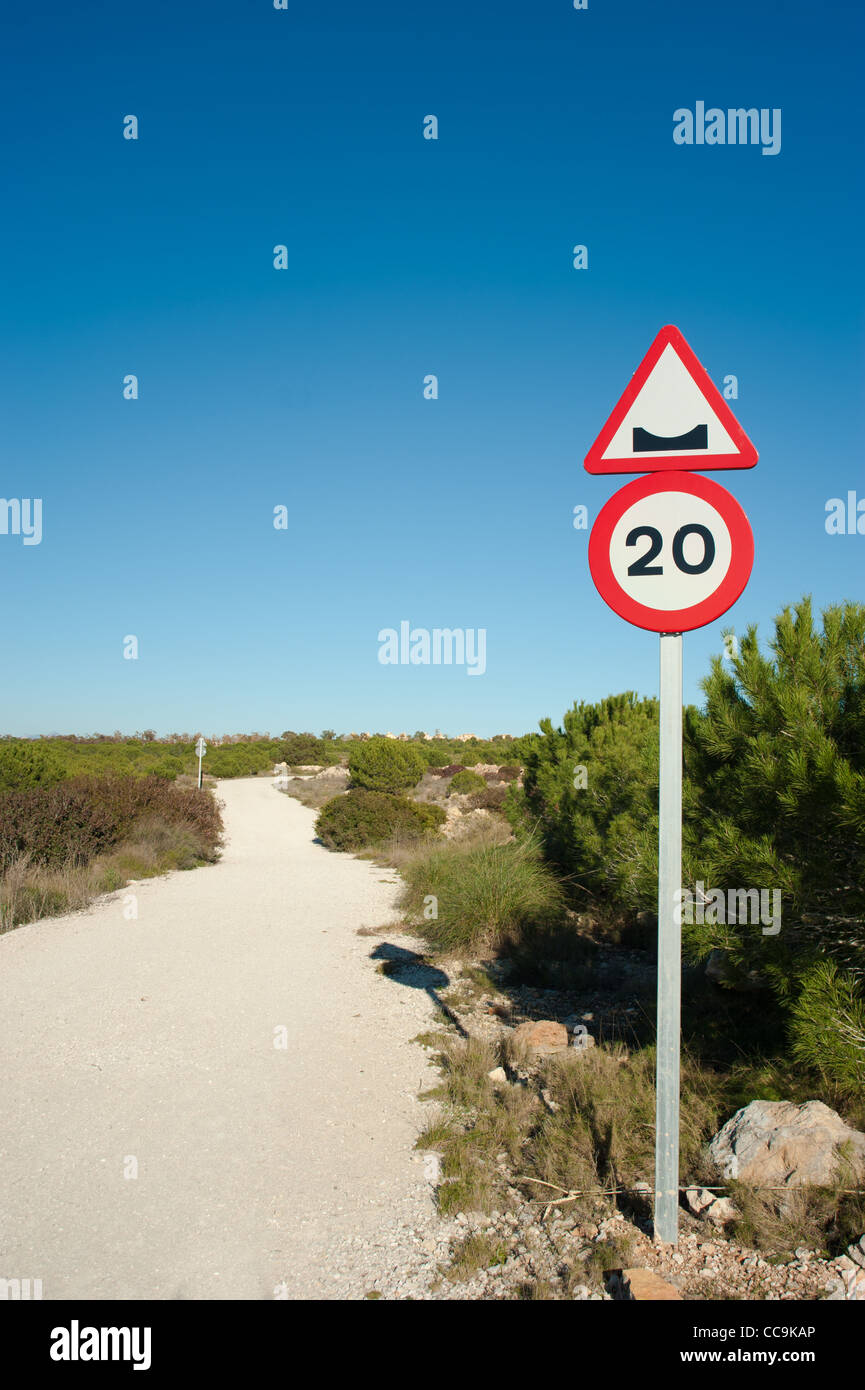 Warning sign on a scenic dirt road Stock Photo - Alamy
