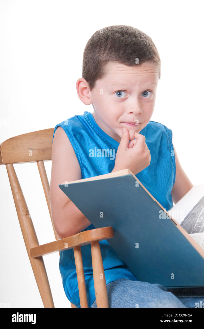 Boy relaxing with book Stock Photo - Alamy