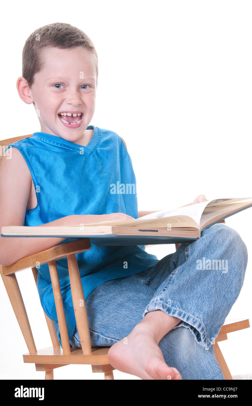 Boy relaxing with book Stock Photo - Alamy