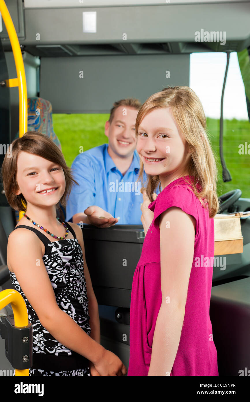 Children boarding a bus and buying a ticket Stock Photo - Alamy