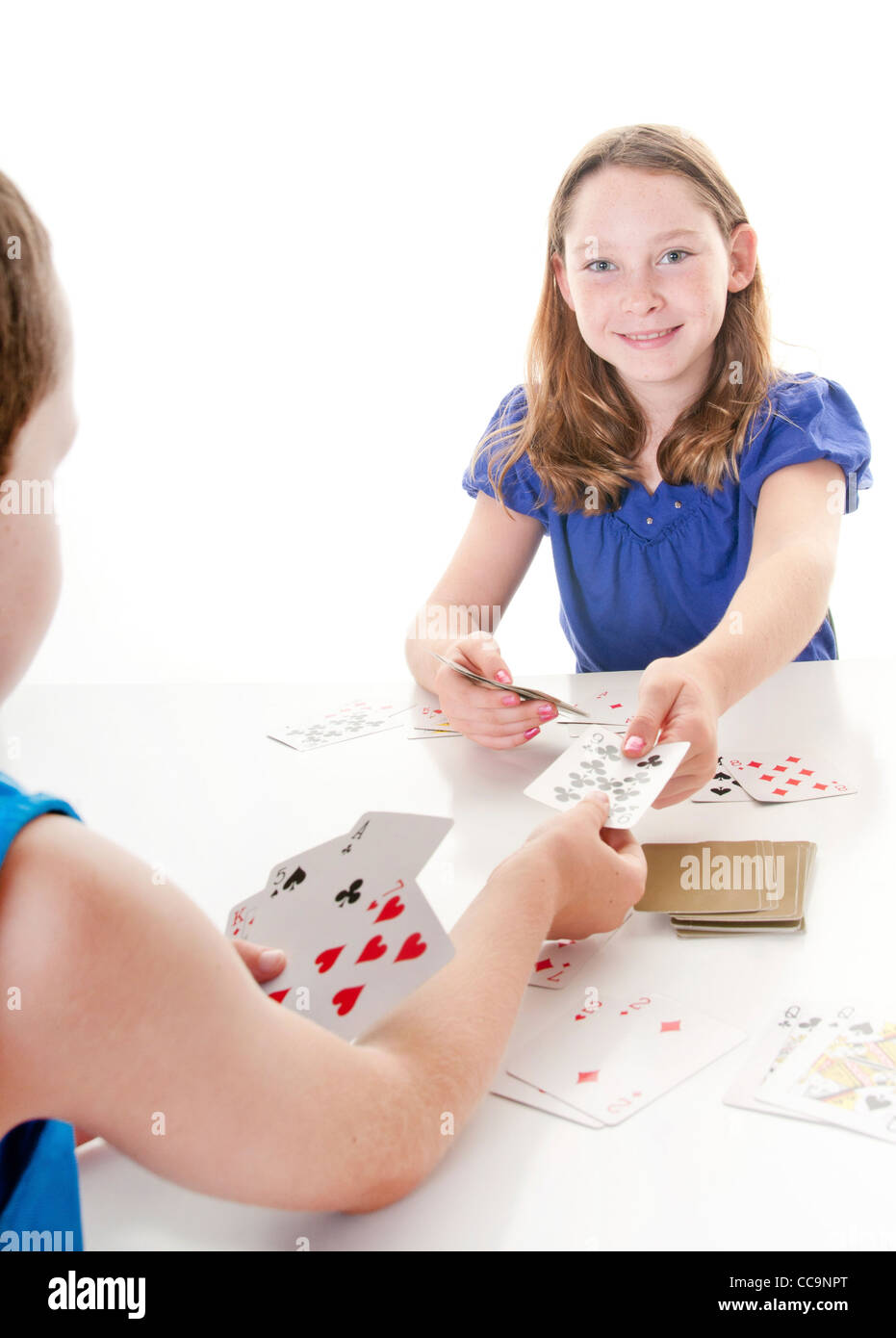 Kids playing card game Stock Photo - Alamy