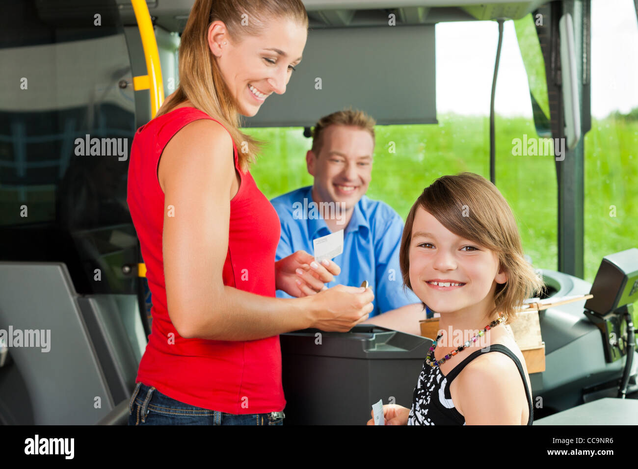 Mother and child boarding a bus and buying a ticket Stock Photo - Alamy