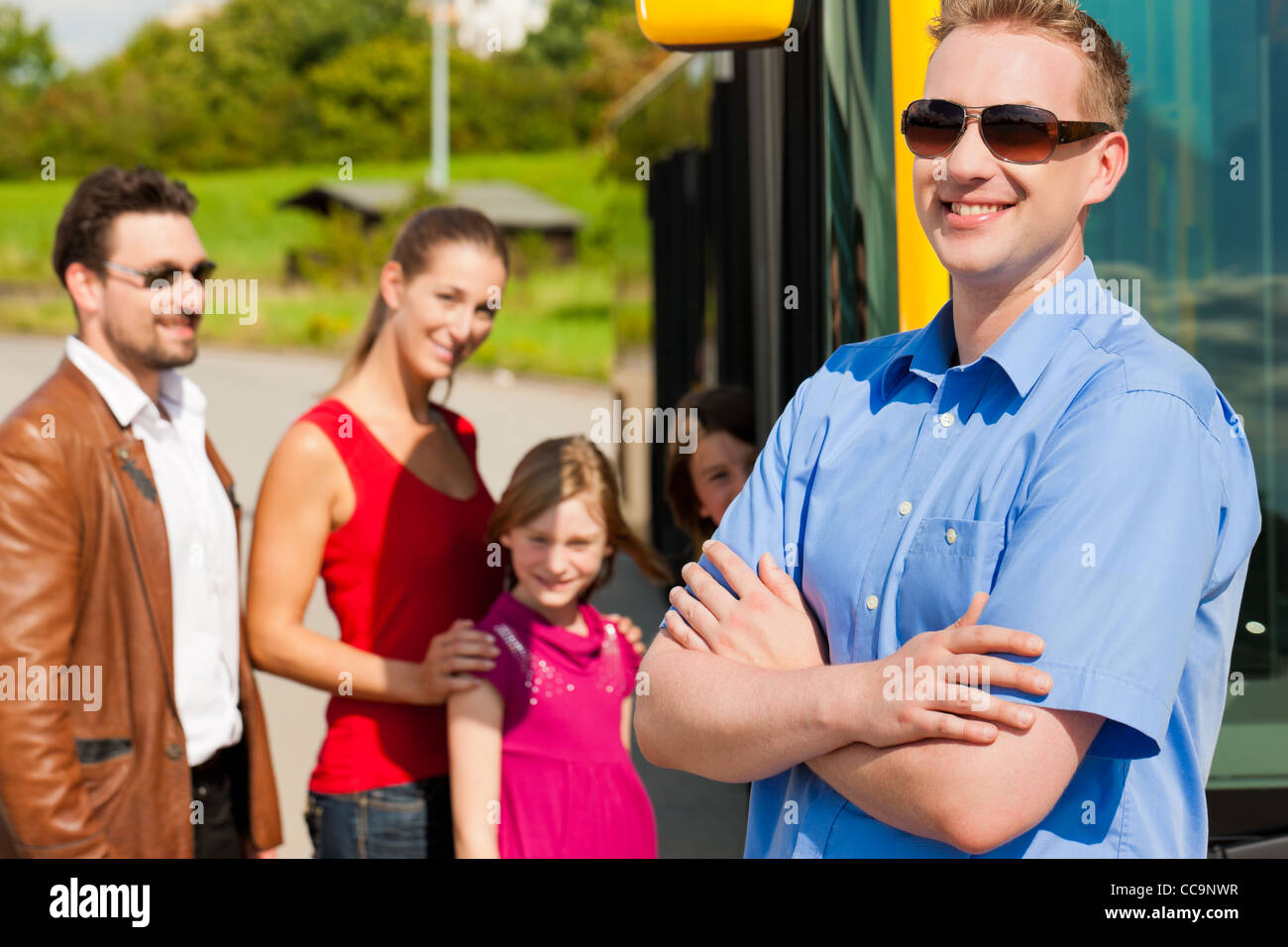 Passengers boarding a bus at a bus station; in the foreground a bus ...
