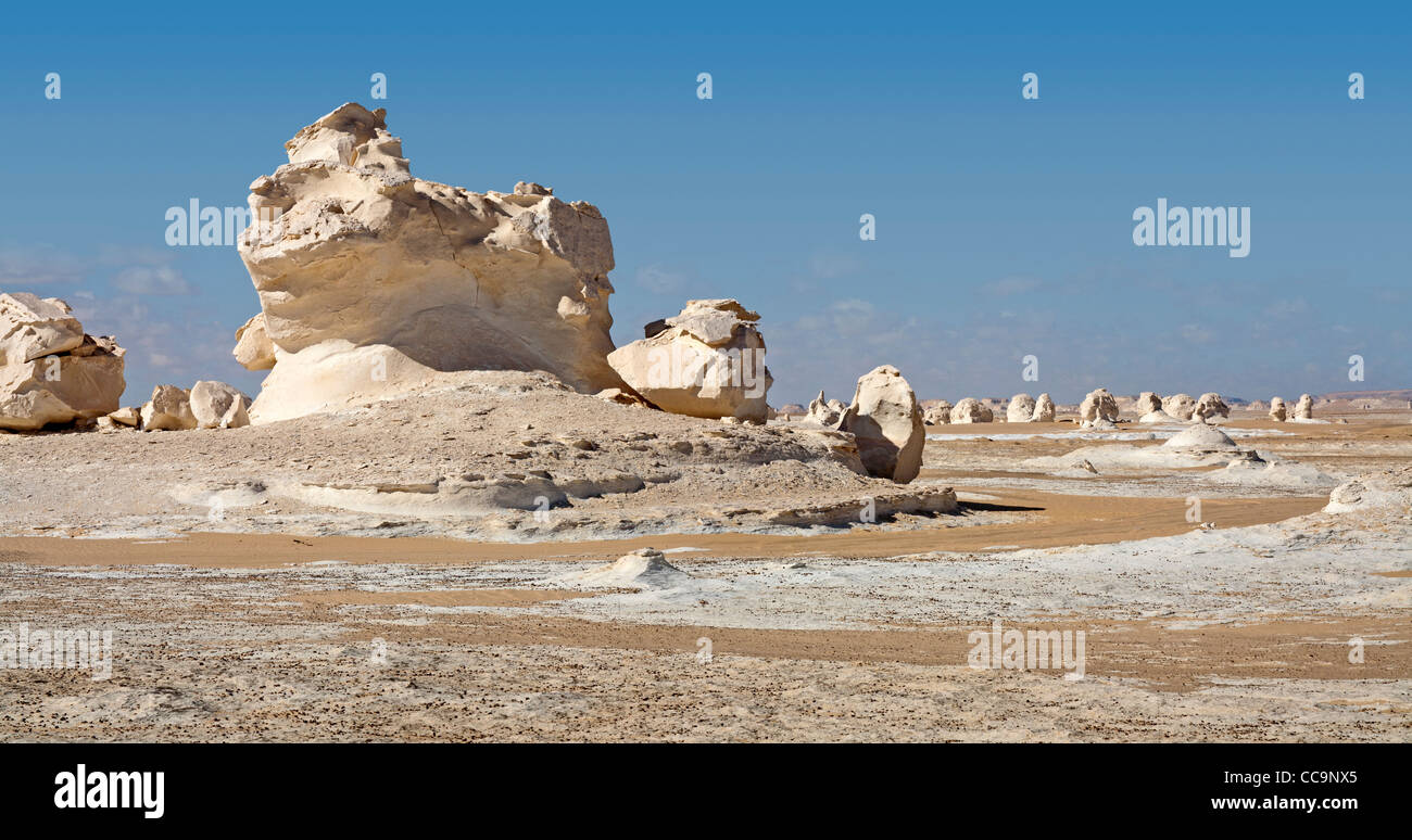 Inselbergs with surrounding ridged sand in the White Desert, close to ...