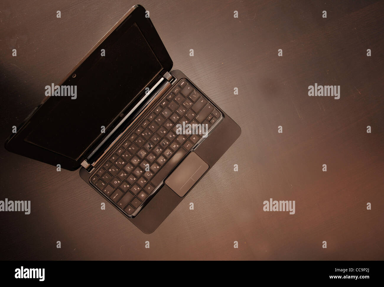 Closeup photo of a thin laptop on office desk from above Stock Photo ...