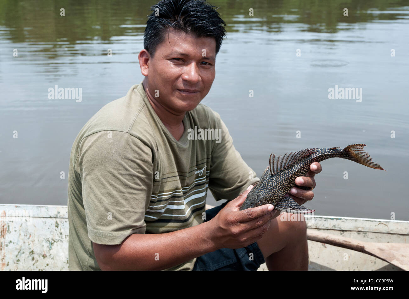 Pacaya Samiria National Reserve, Peru. Man holding a prehistoric ...