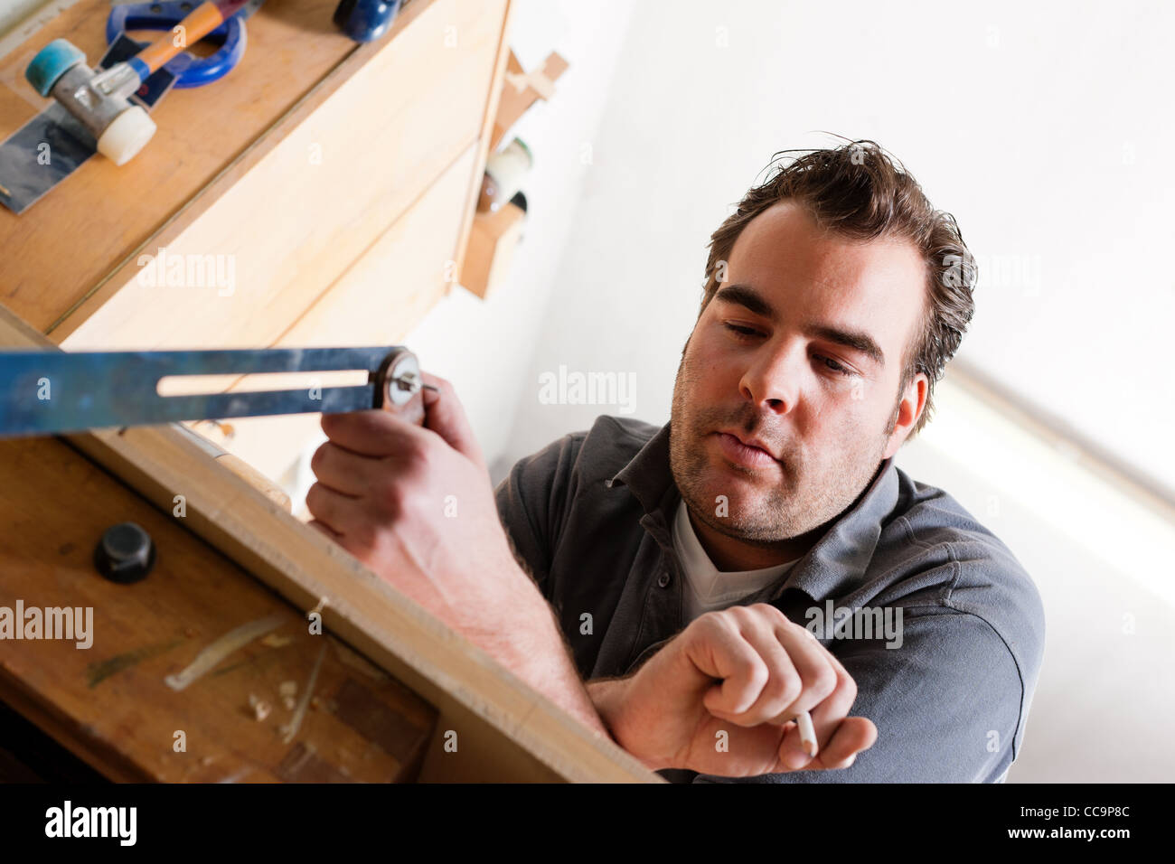 Carpenter working with angle and pencil in his workshop Stock Photo - Alamy