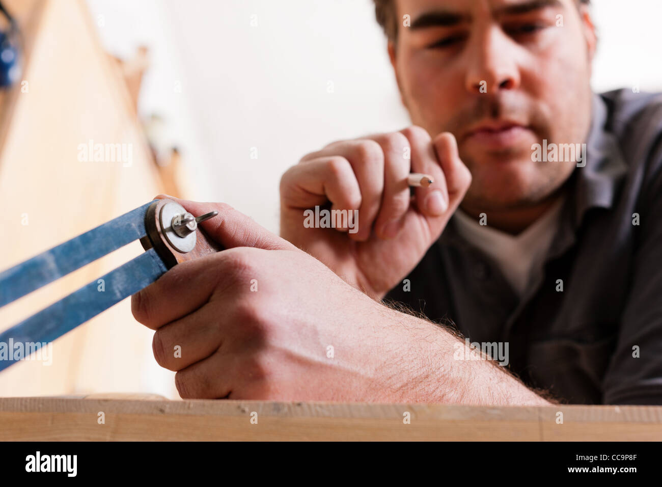 Carpenter working with angle and pencil in his workshop Stock Photo - Alamy