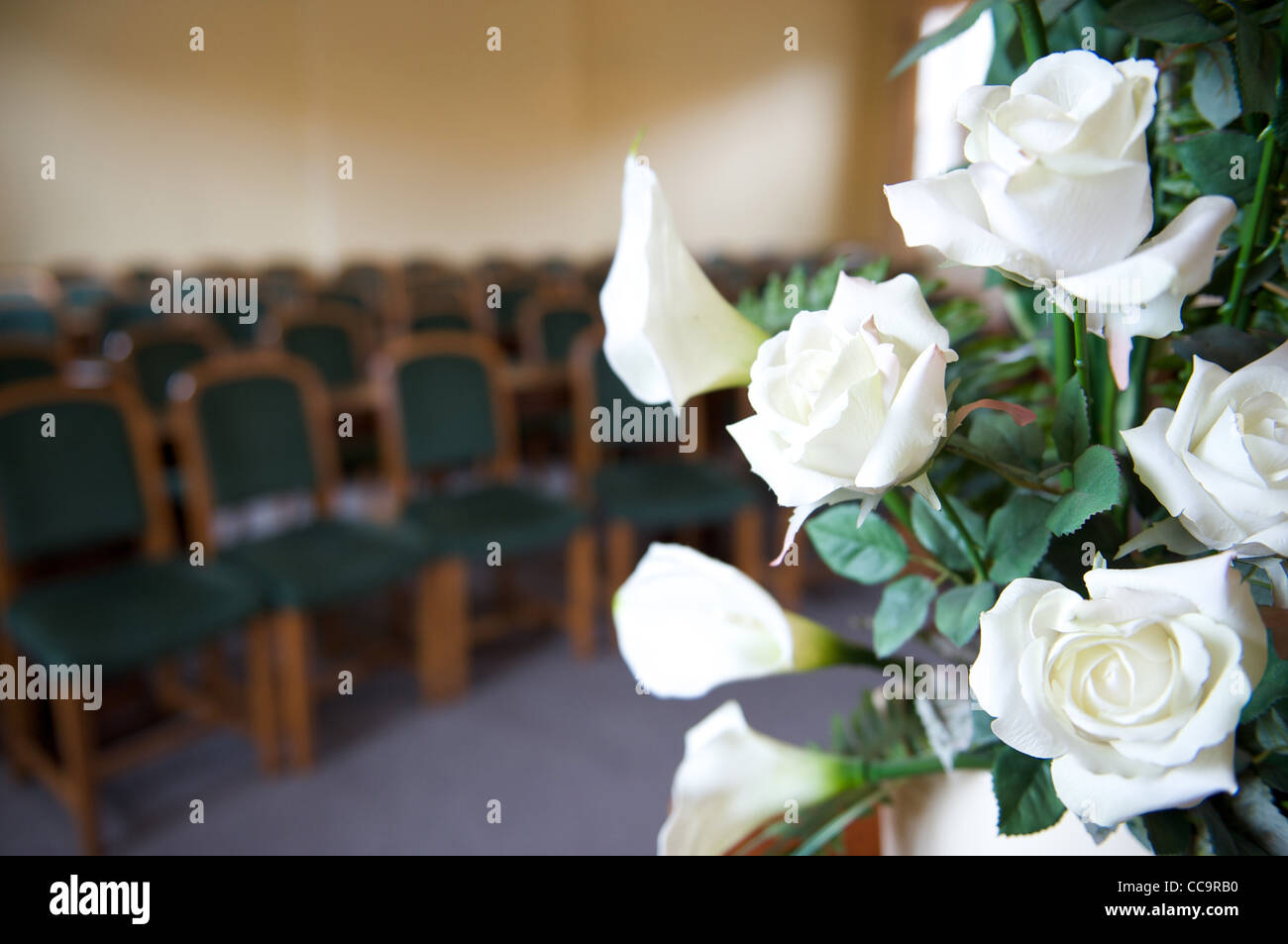 White roses on display at the front of an empty ceremony room Stock ...