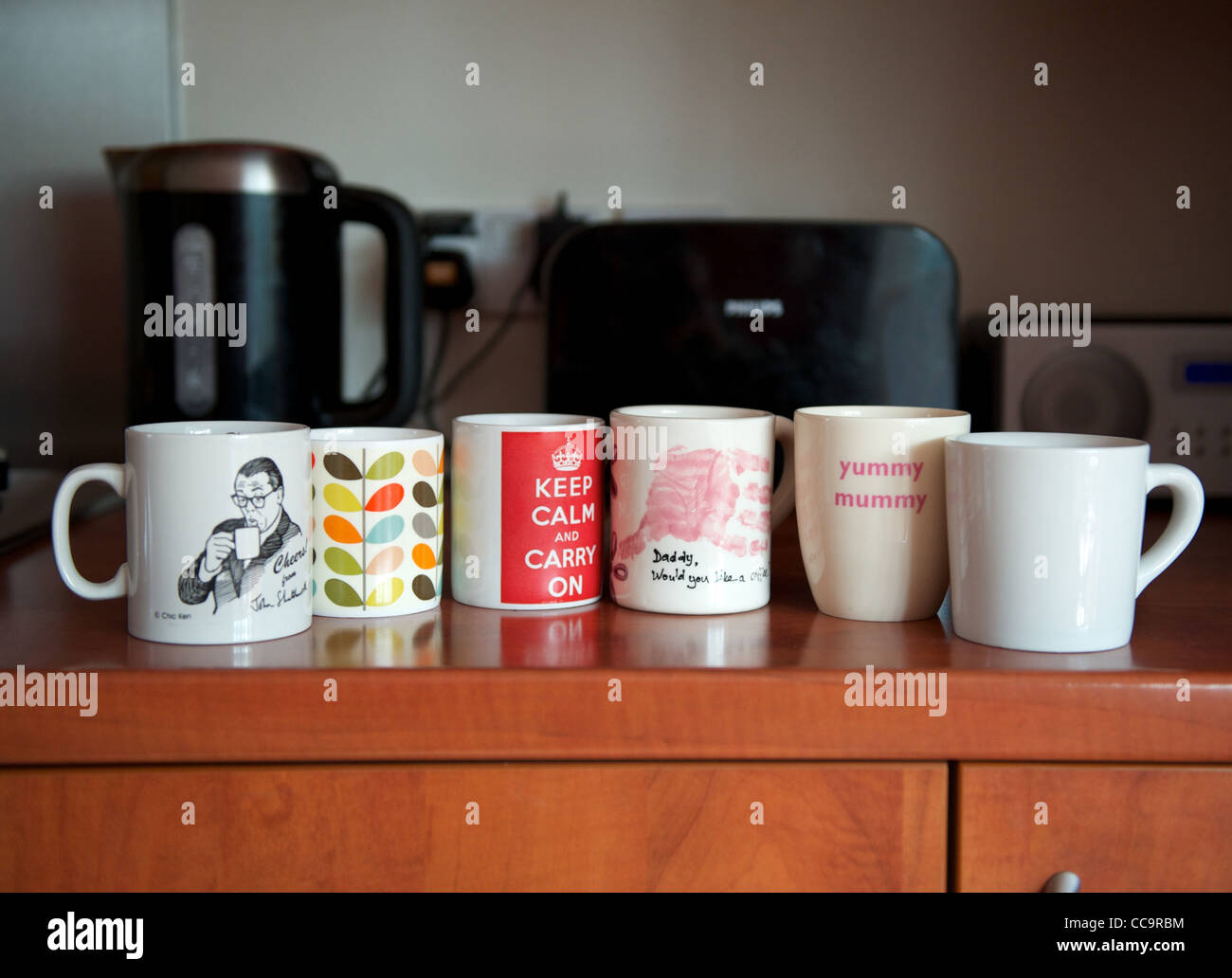 A line of various mugs in a kitchen Stock Photo - Alamy