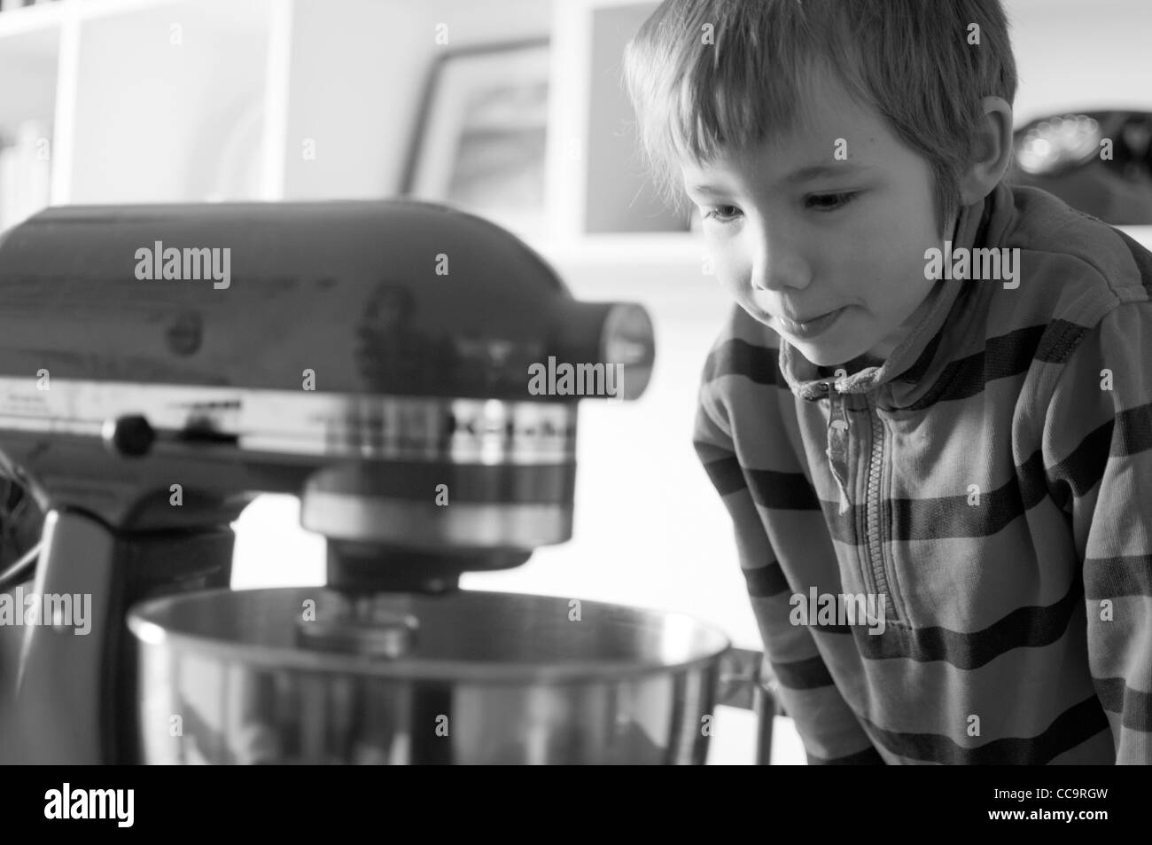Boy mixing chocolate in kitchen hi-res stock photography and images - Alamy