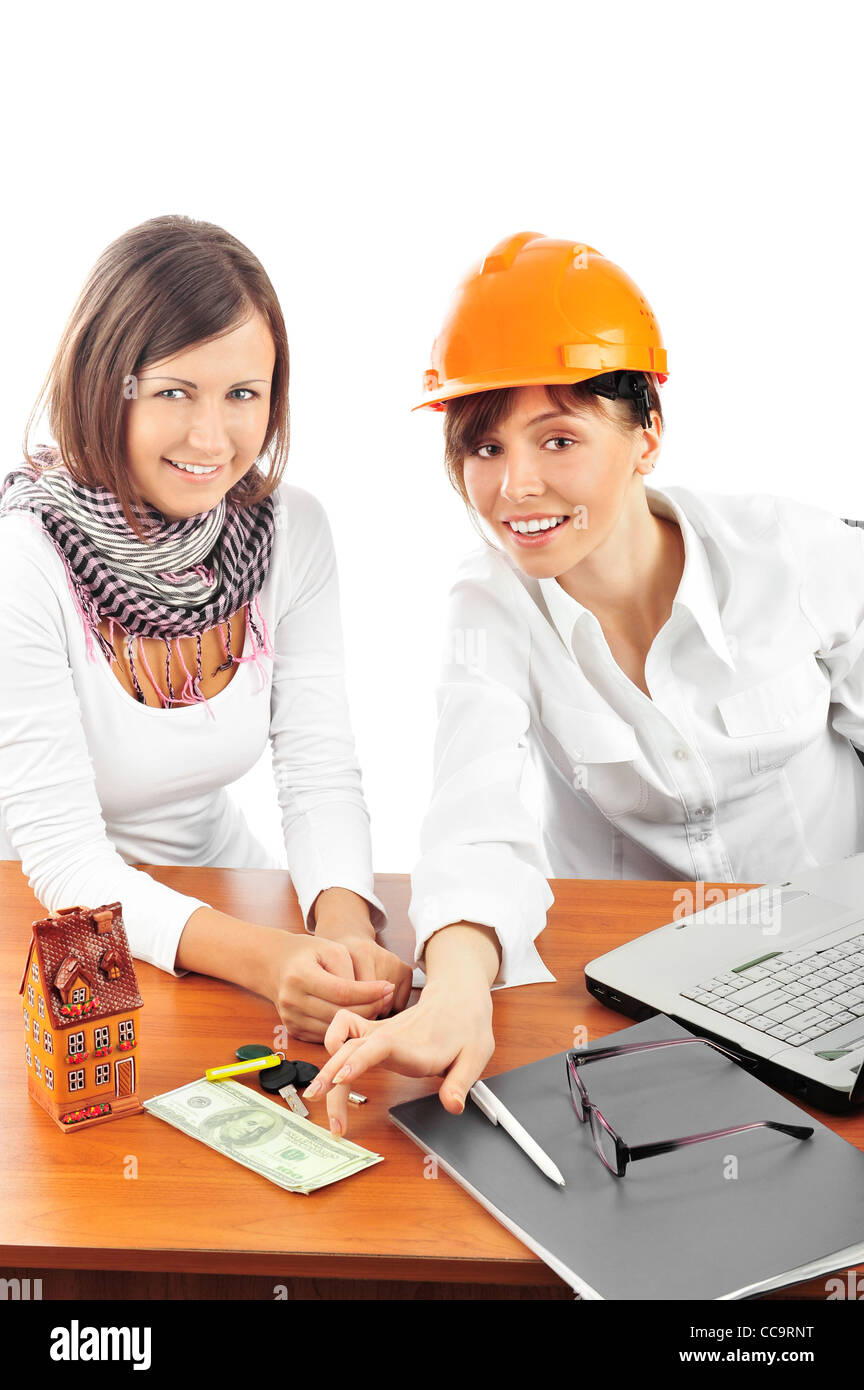 Portrait of two young women discussing building construction project ...