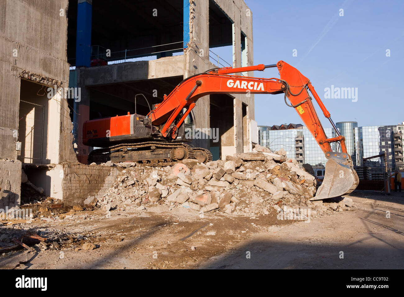A digger clearing waste from a demolition site in Tours, France Stock ...