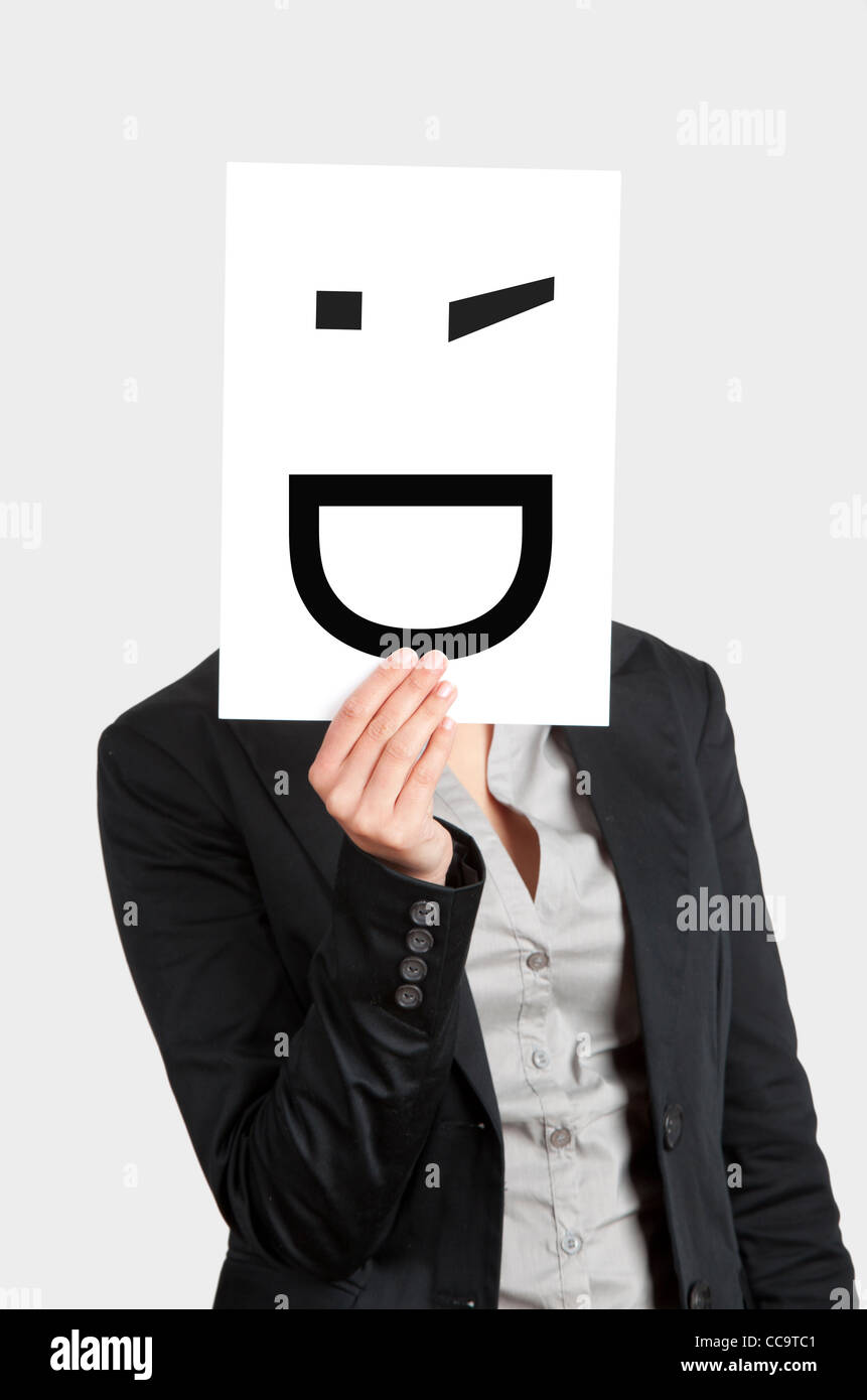 Woman showing a blank paper with a smile winking in front of her face ...