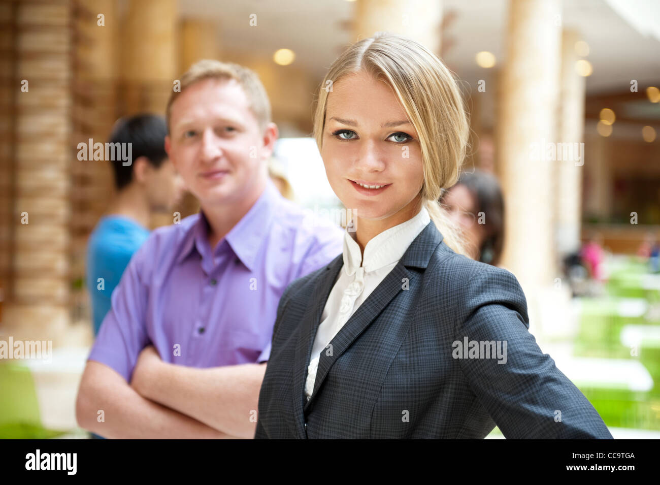 Portrait of a cute business woman with colleagues at the background ...
