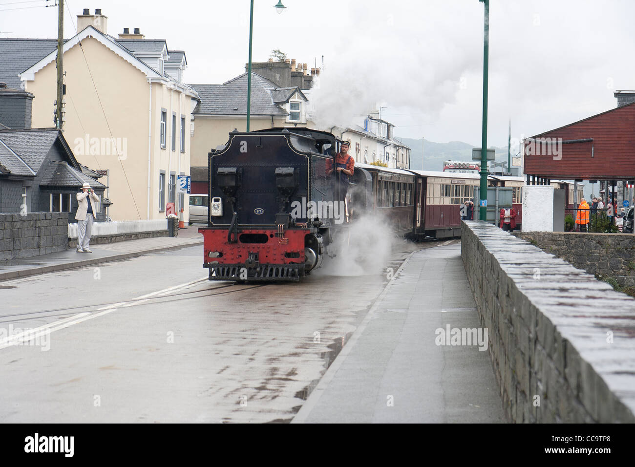 A steam locomotive with a passenger train on the Welsh Highland Line ...