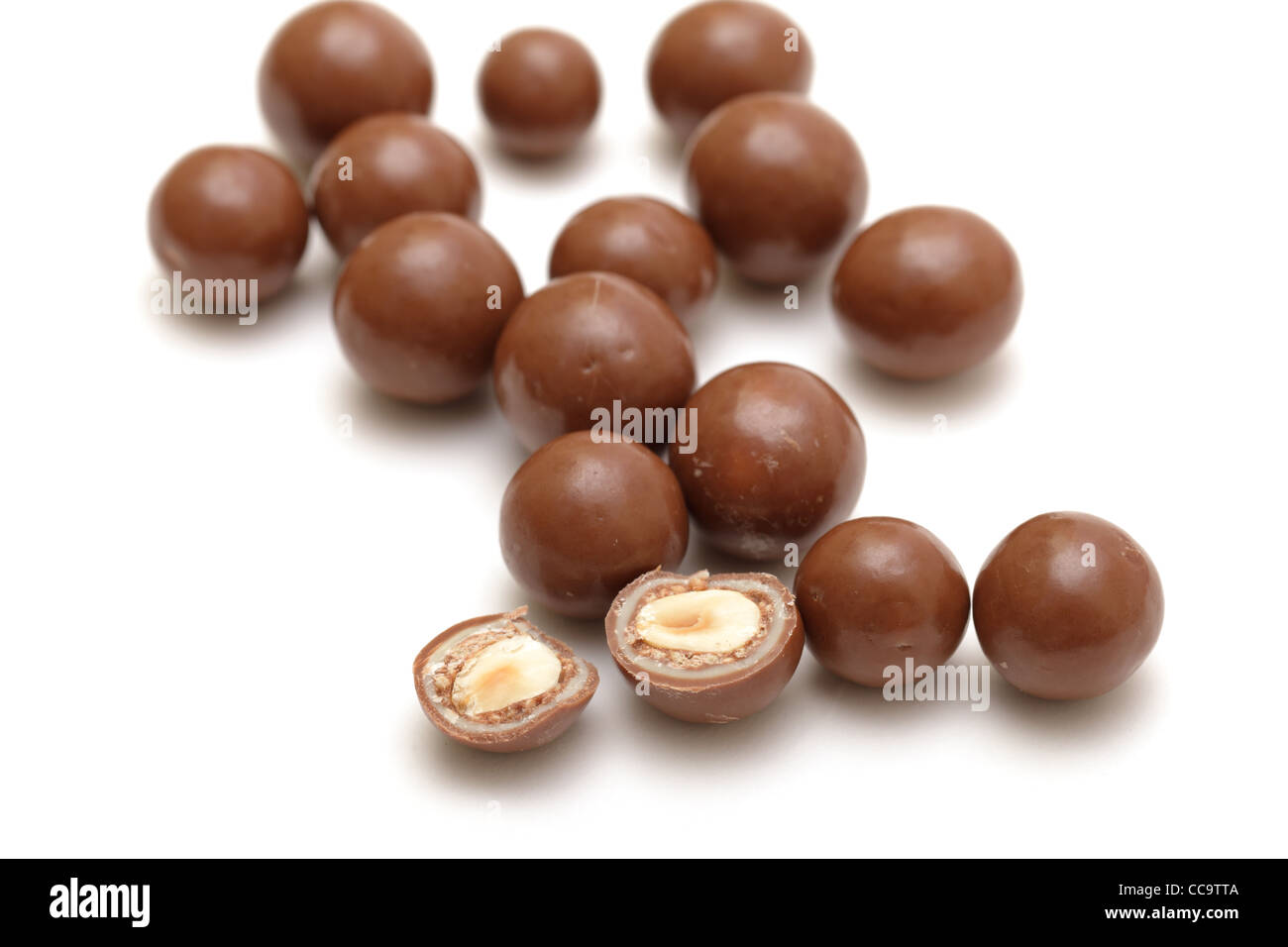 chocolate balls with nuts on a white background Stock Photo - Alamy