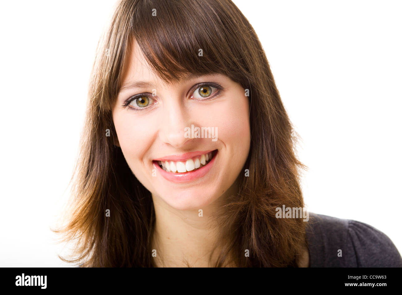 Portrait of a beautiful young woman looking at the camera and smiling ...