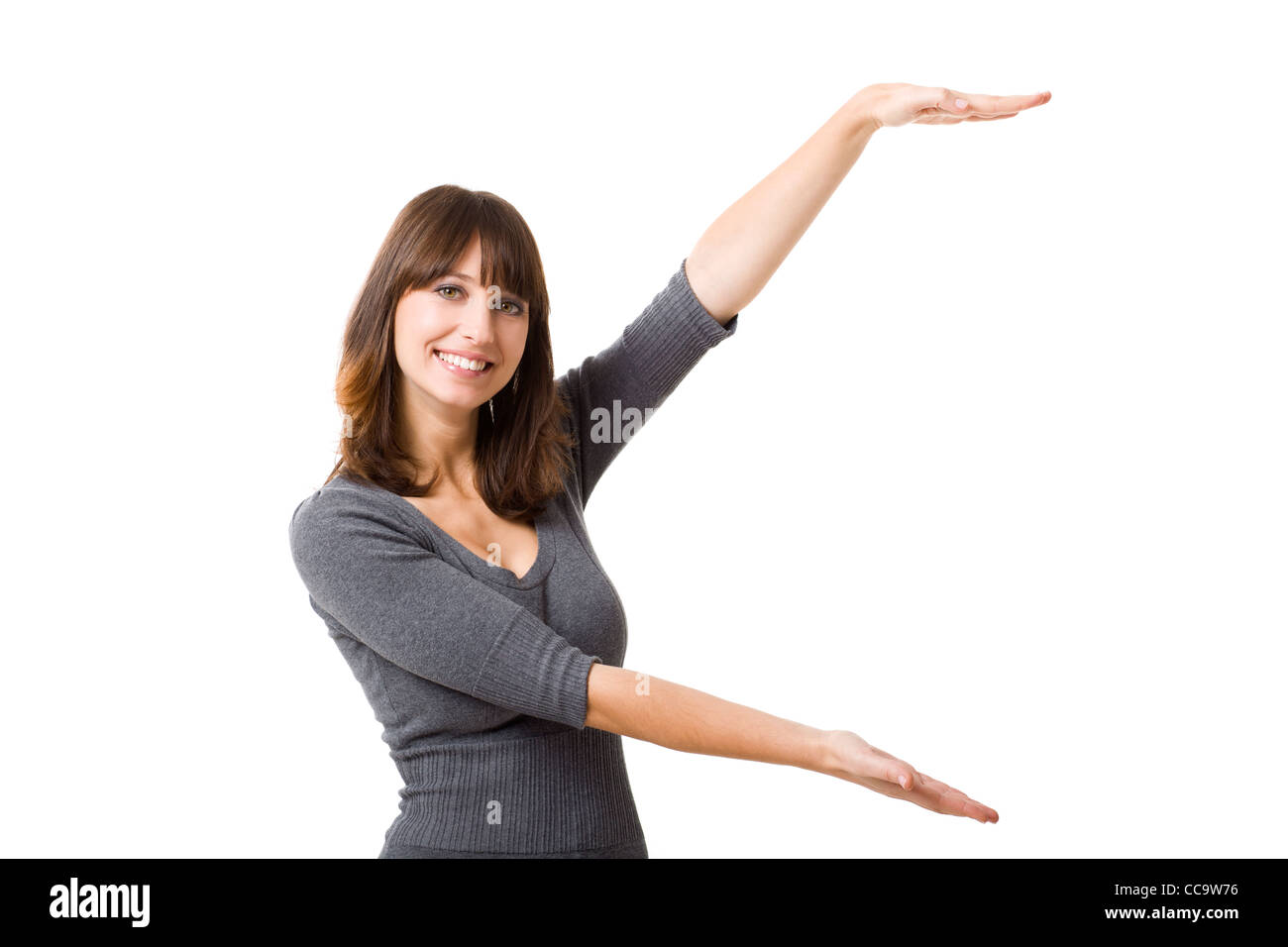 Portrait of a beautiful young woman showing her arms open, isolated on ...