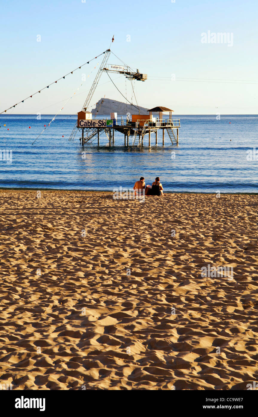 couple looks at cable ski ride at Playa Levante Beach in Benidorm ...