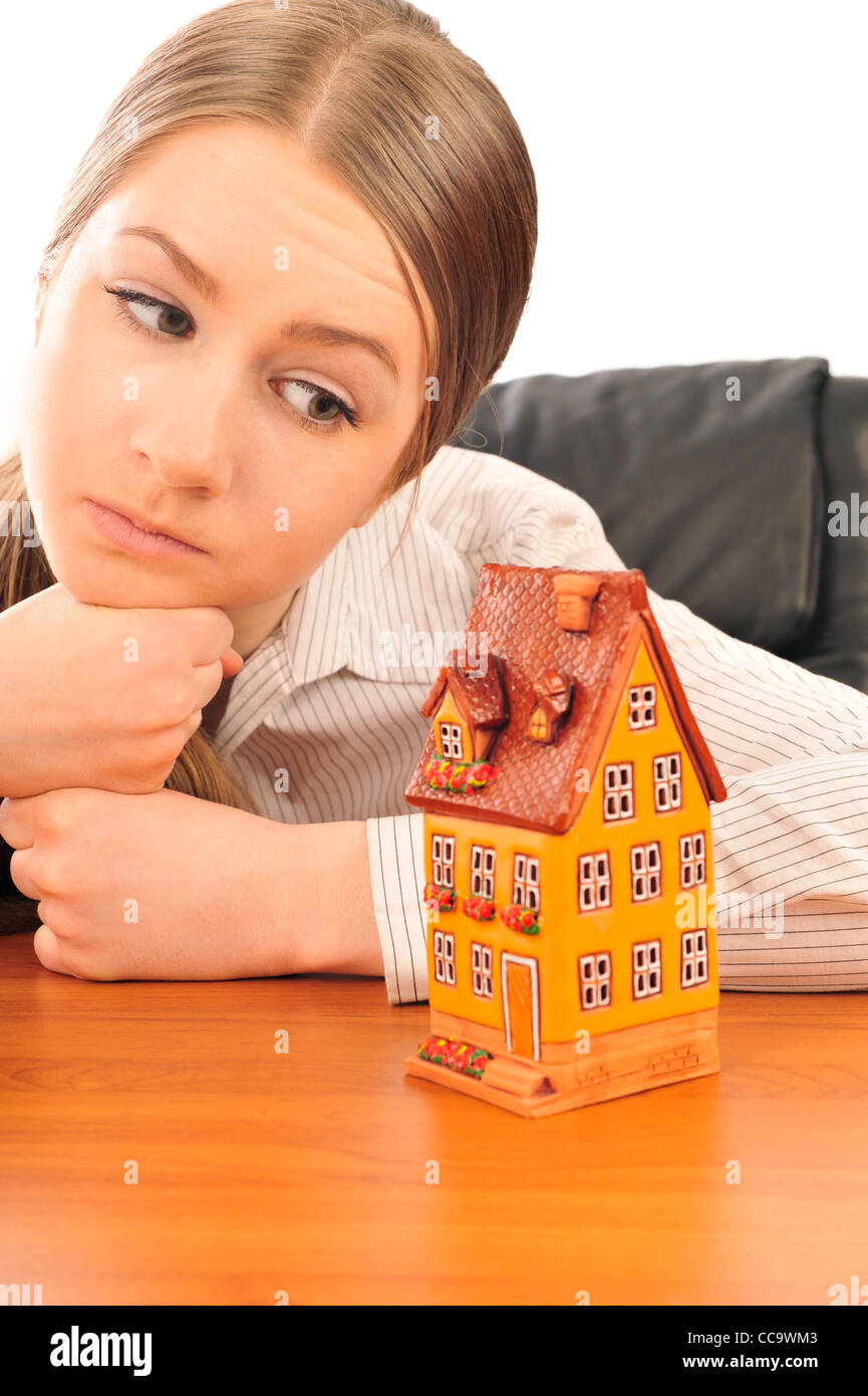 Young beautiful business woman with house model - real estate. Sitting ...