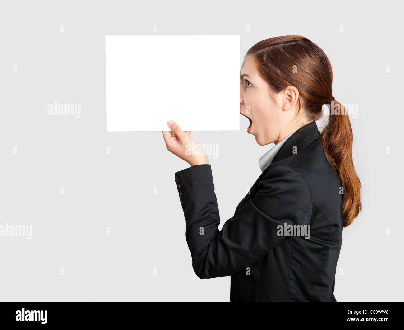 Woman holding a paper sheet on her nose Stock Photo - Alamy