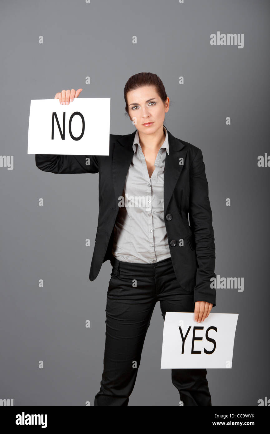 Business young woman trying to make a decision between Yes or No choice ...