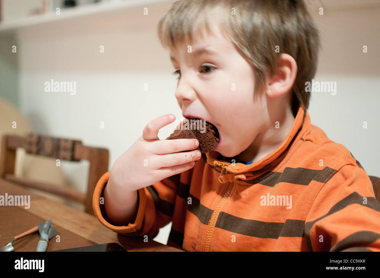 Two little boys making a cake - Little boy eating a slice of cake Stock ...