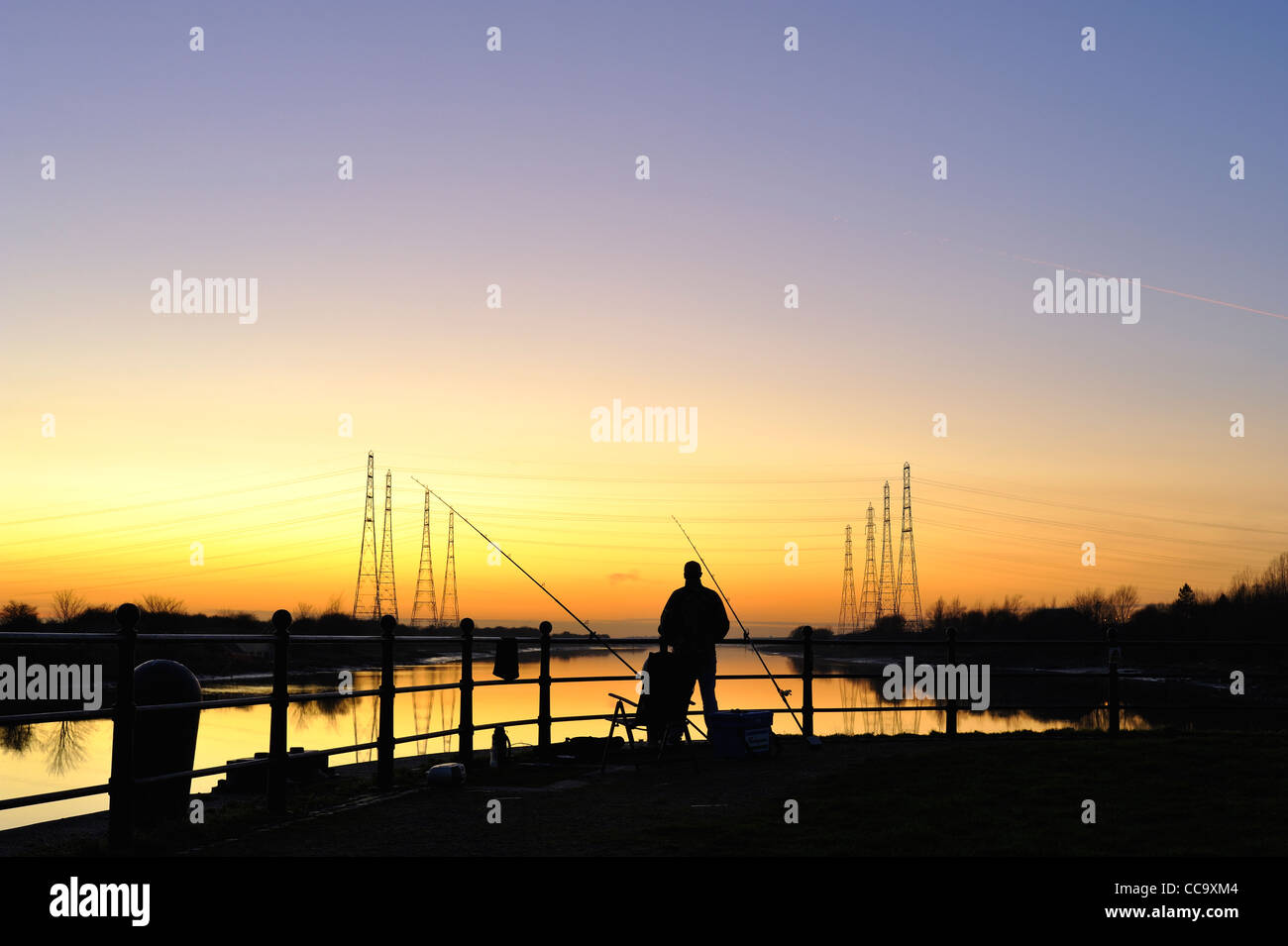 Fishing into the sunset from the bullnose, Preston dock entrance Stock ...