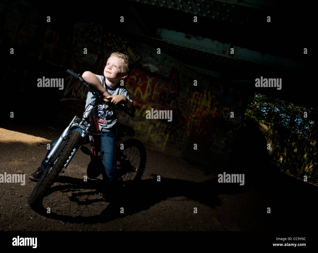Boy leaning on handlebars of bike hi-res stock photography and images ...
