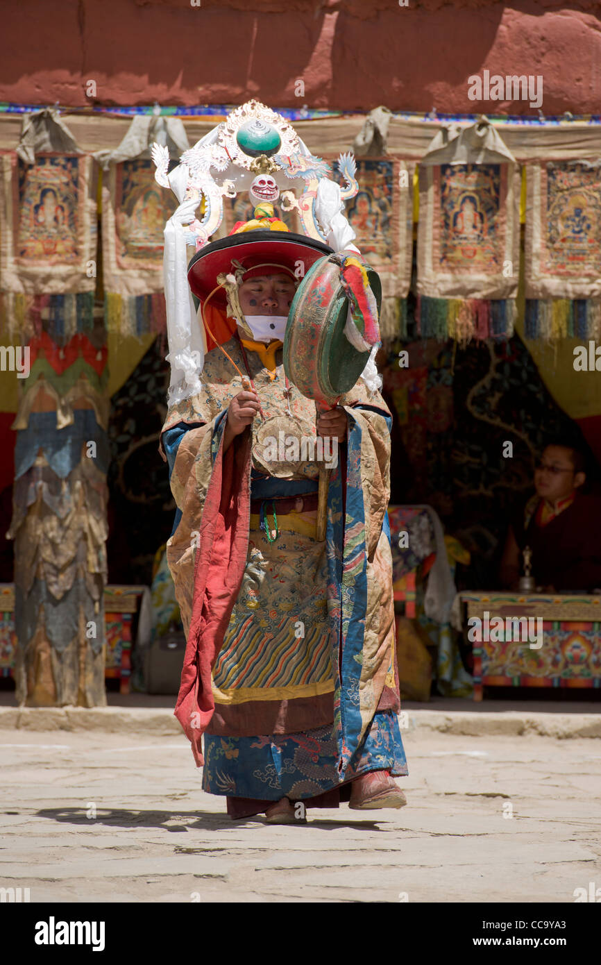 Cham dancer performing the Black Hat Dance (shana) with a drum in the ...