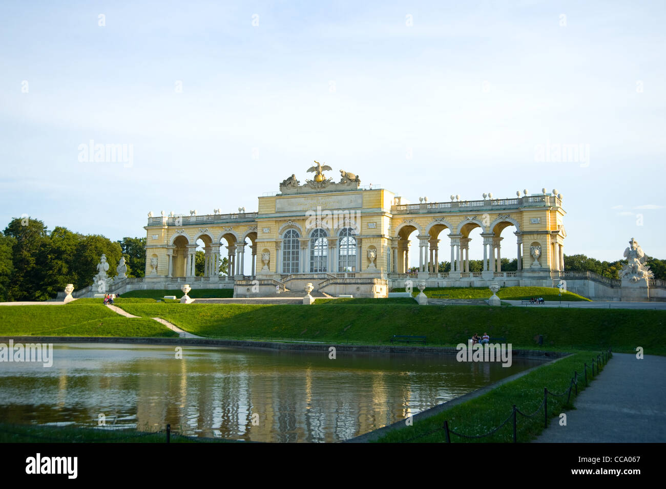 Belvedere Palace rotunda in Vienna at sunset, pond water yellow color ...