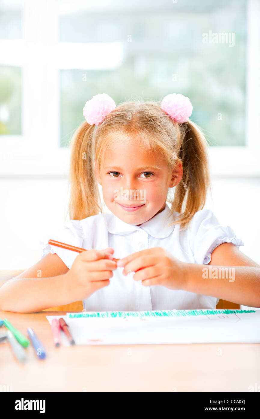 Little girl looking for a drawing concept wile painting picture on ...