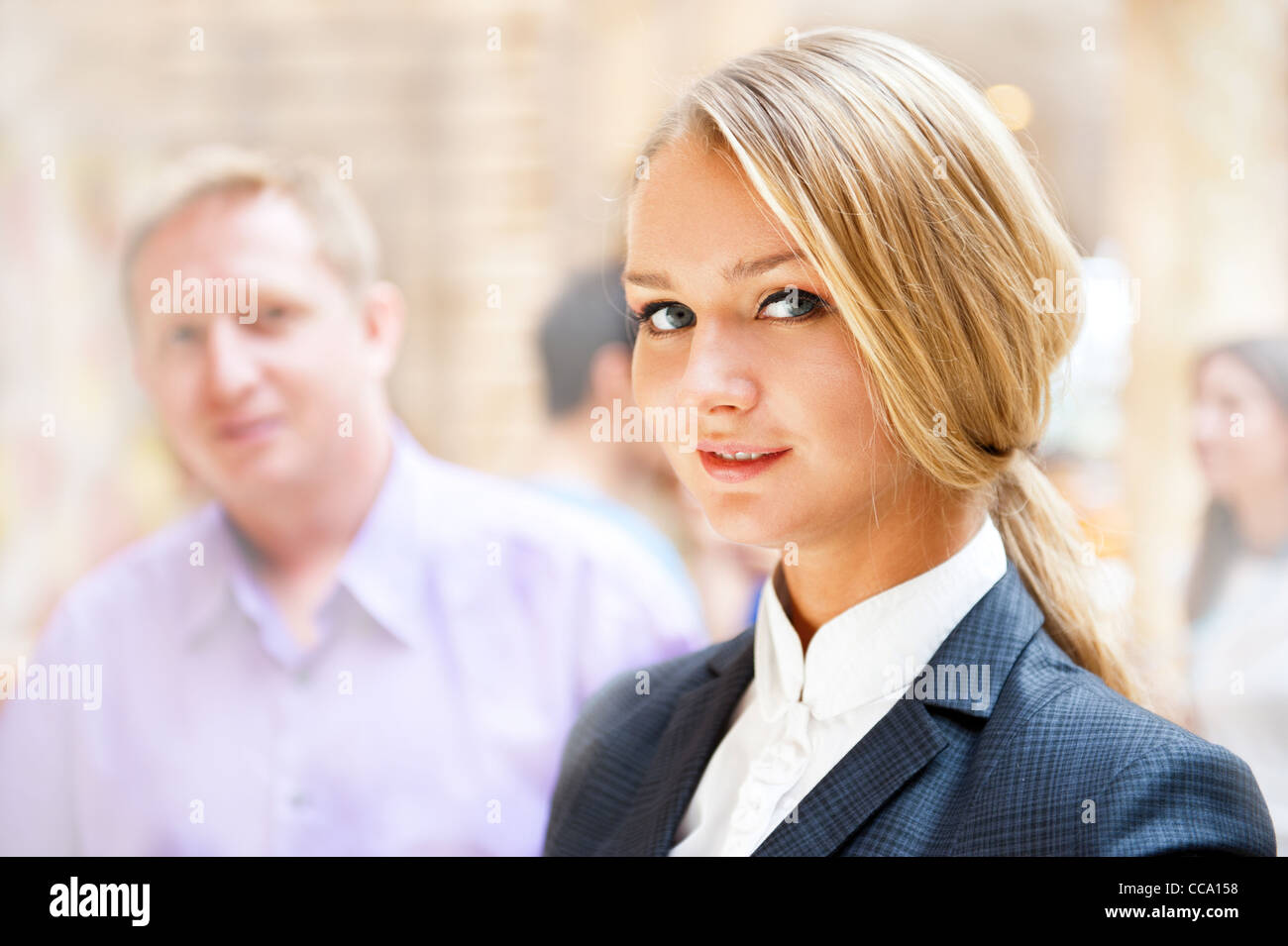 Portrait of a cute business woman with colleagues at the background ...