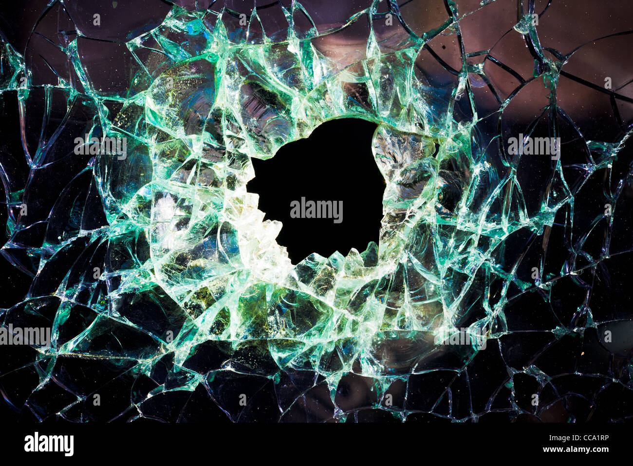 A hole broken in glass Stock Photo - Alamy