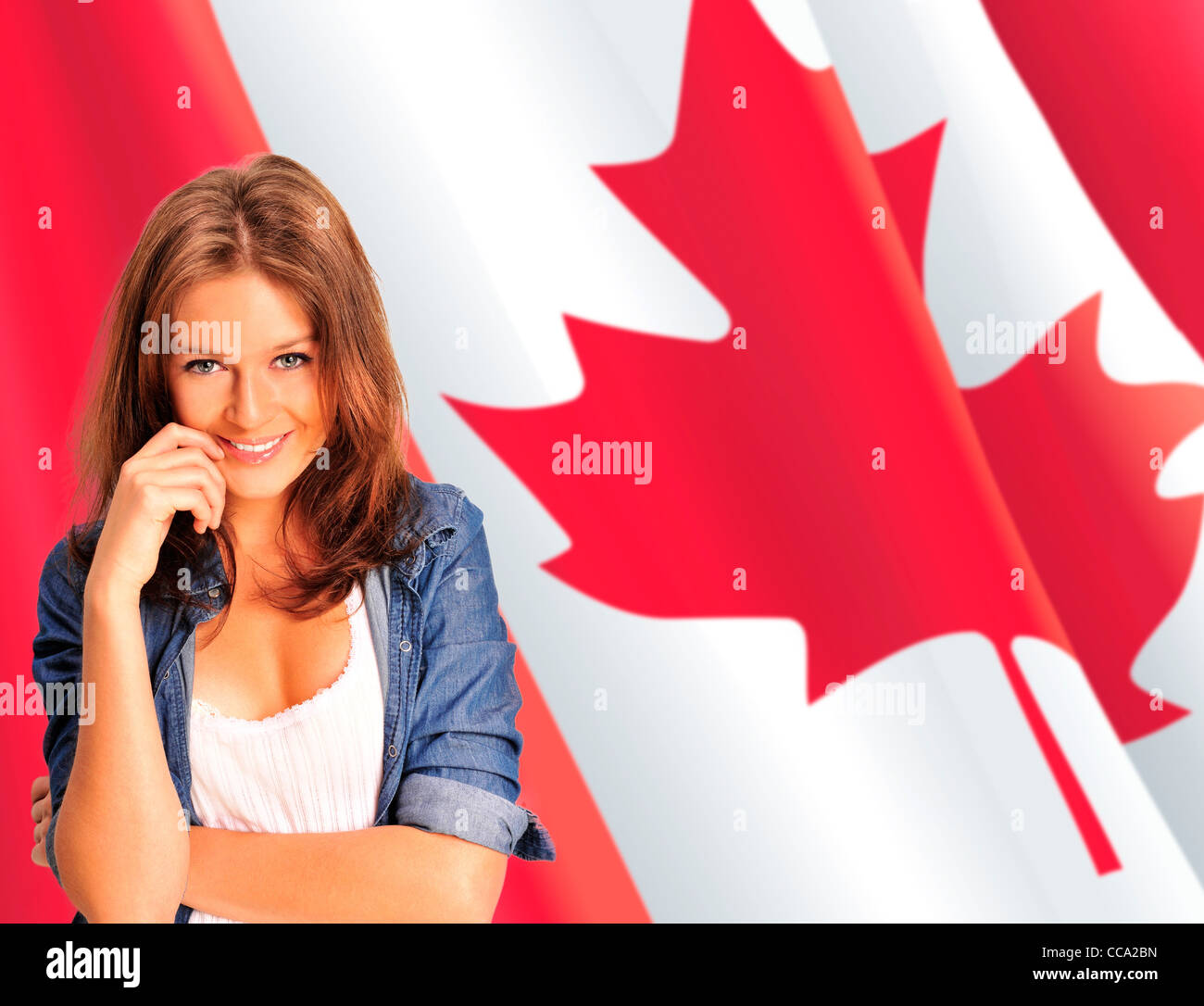 Portrait of a pretty young woman against a Canadian flag , smiling ...