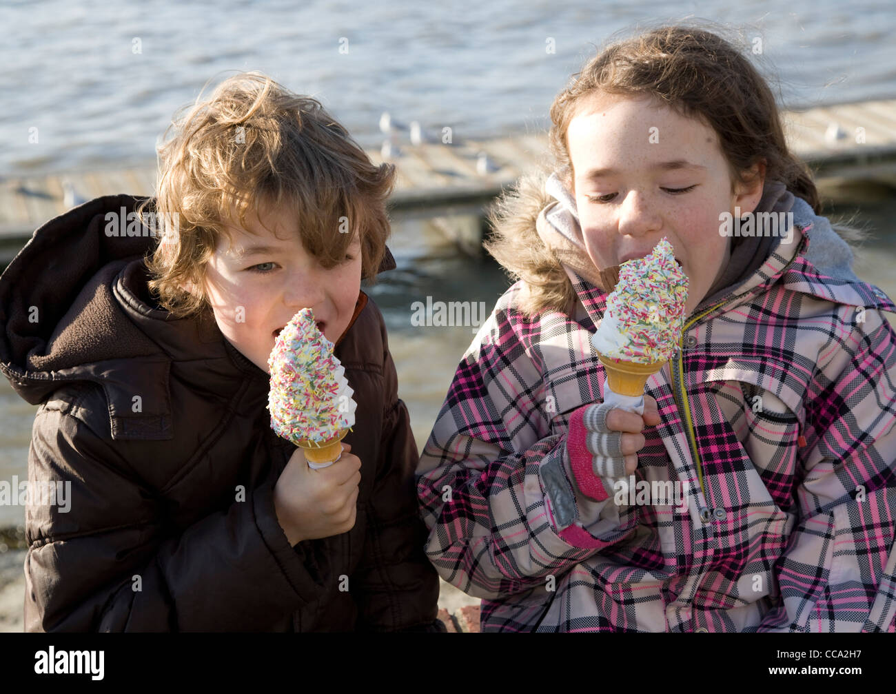 Children eating ice cream on a cold January day Stock Photo - Alamy