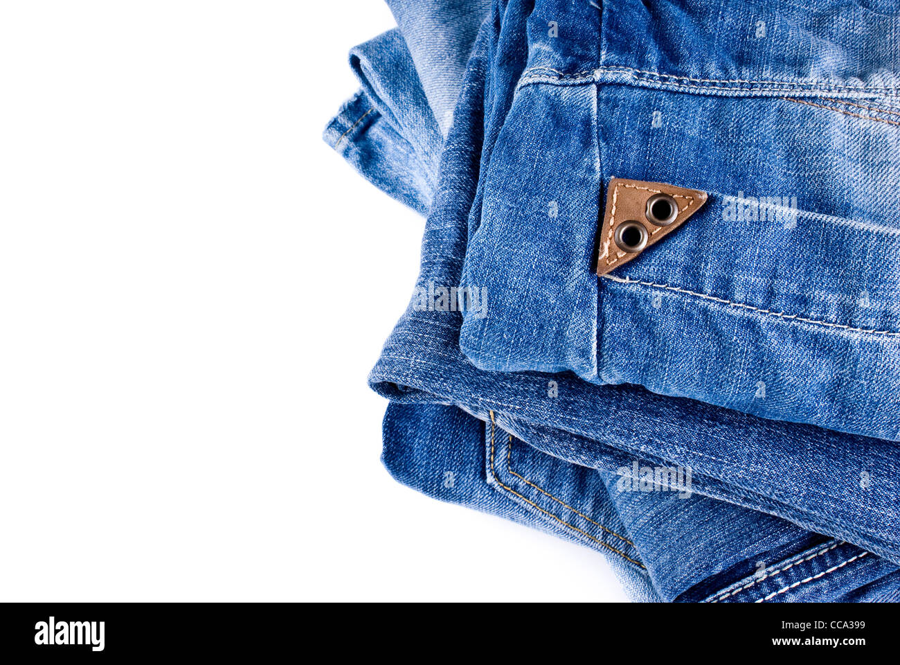 stack of various shades of blue jeans over white background Stock Photo ...