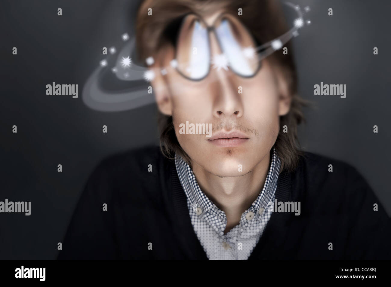 Young Business man against gray background. Distorted head and circles ...