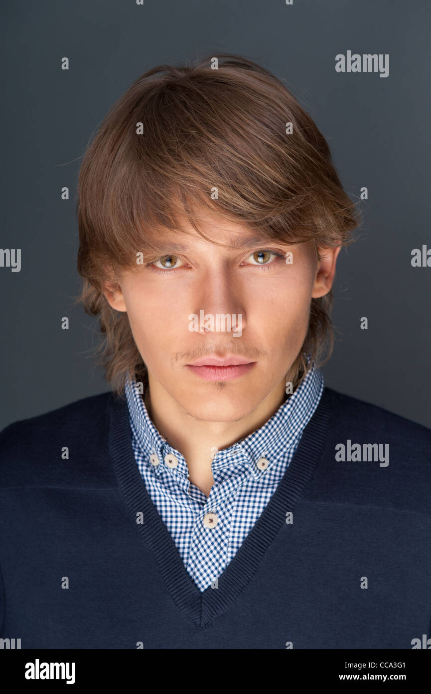 Portrait of young man with smart and wise look. Looking at camera Stock ...