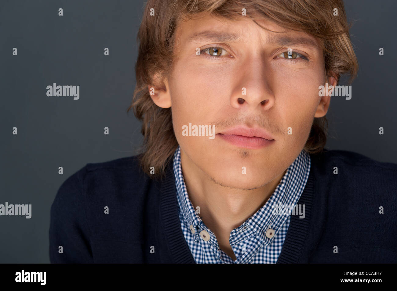 Portrait of young man with smart and wise look. Looking at camera Stock ...