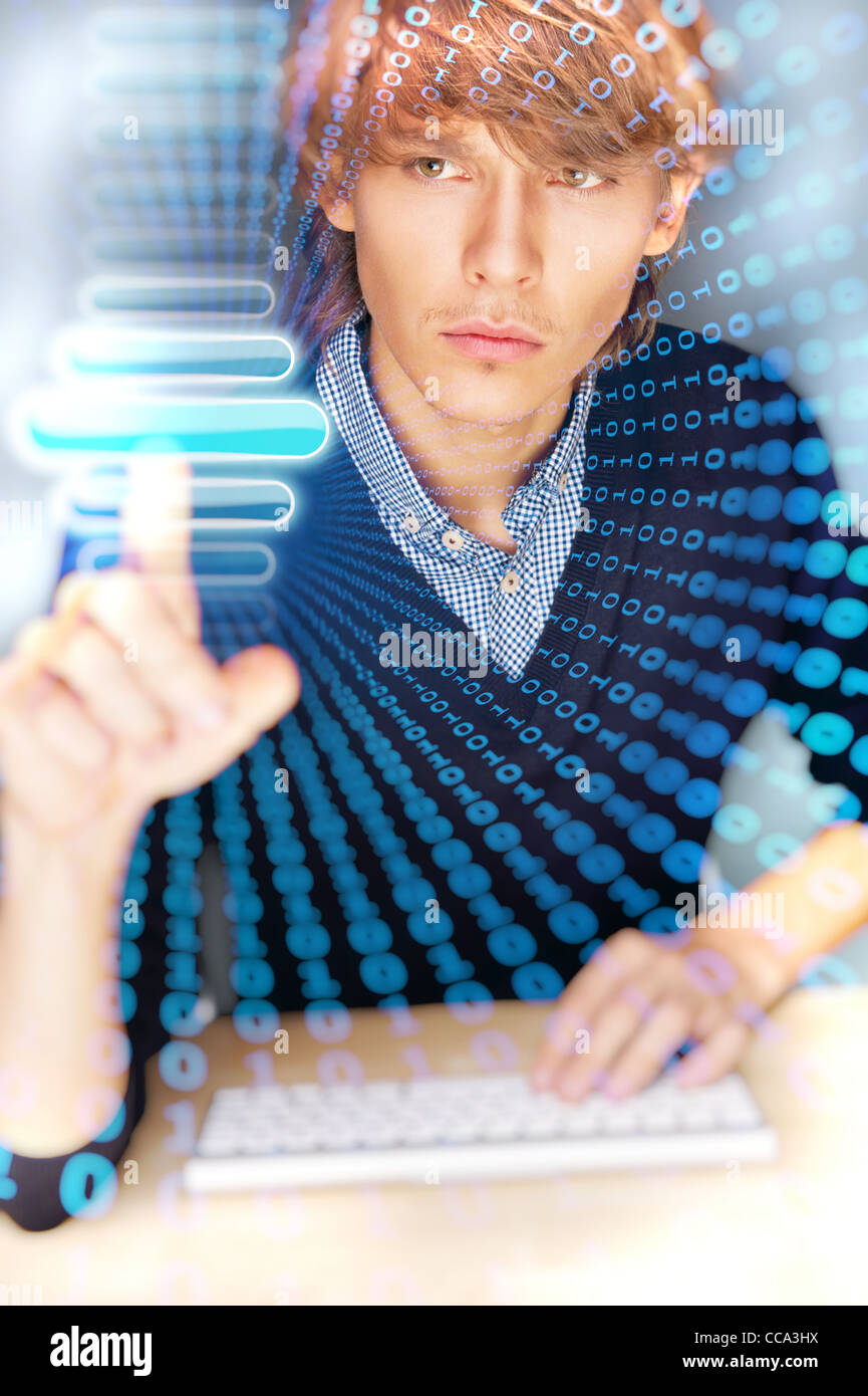 Young business man pressing a touchscreen button while working at his ...