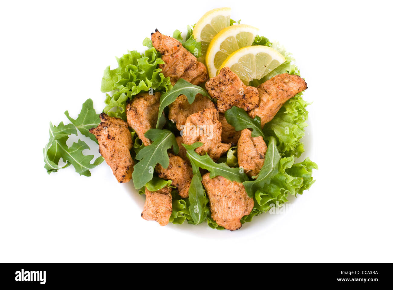 Chicken salad with dropped leaves over white background Stock Photo - Alamy