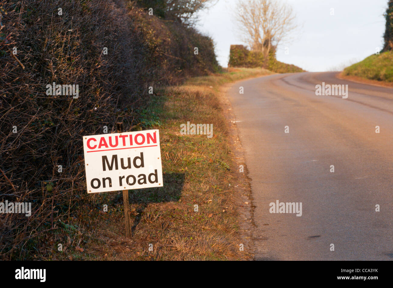 'Caution Mud on Road' sign on an empty Norfolk country lane Stock Photo ...