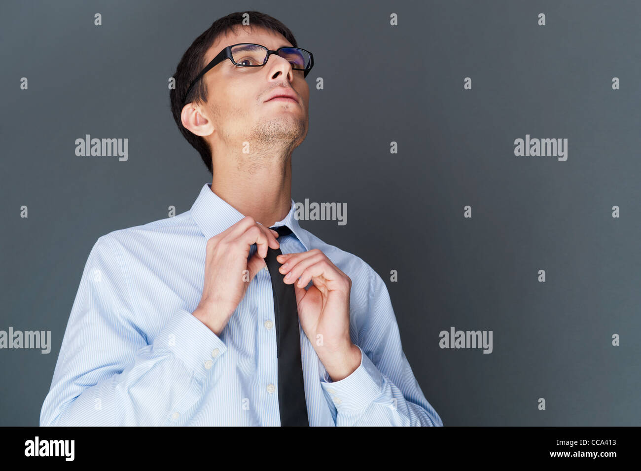 Portrait of a good looking Caucasian American business man against grey ...