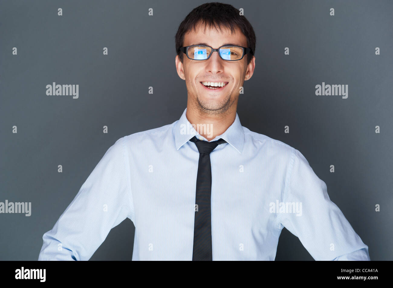 Portrait of a good looking Caucasian American business man against grey ...