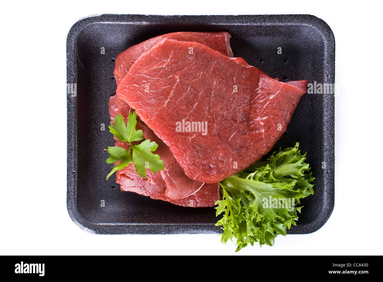 Raw beef frying steak in black tray isolated over white background ...