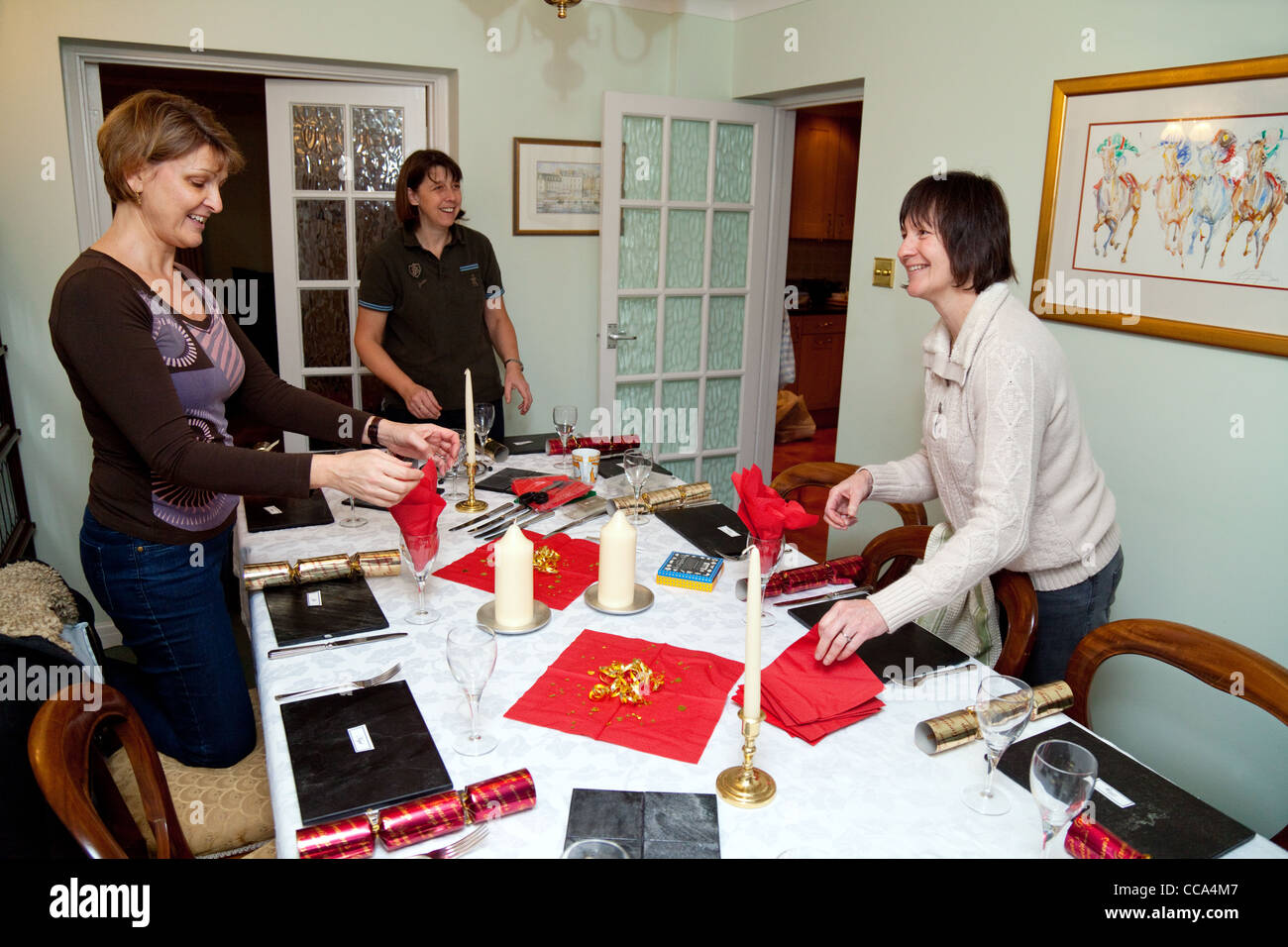 Three women preparing the table for a dinner party, UK Stock Photo - Alamy