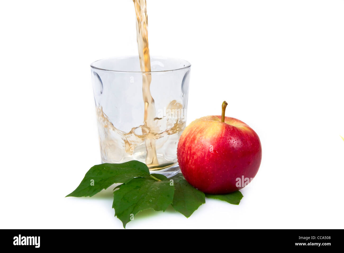 Pouring apple juice - isloated over white Stock Photo - Alamy