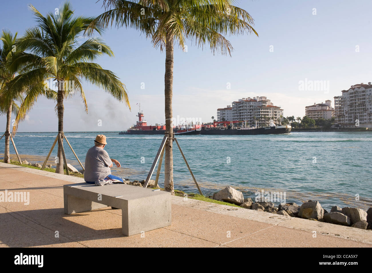 A senior citizen sitting on the quayside at South Pointe Park Miami ...